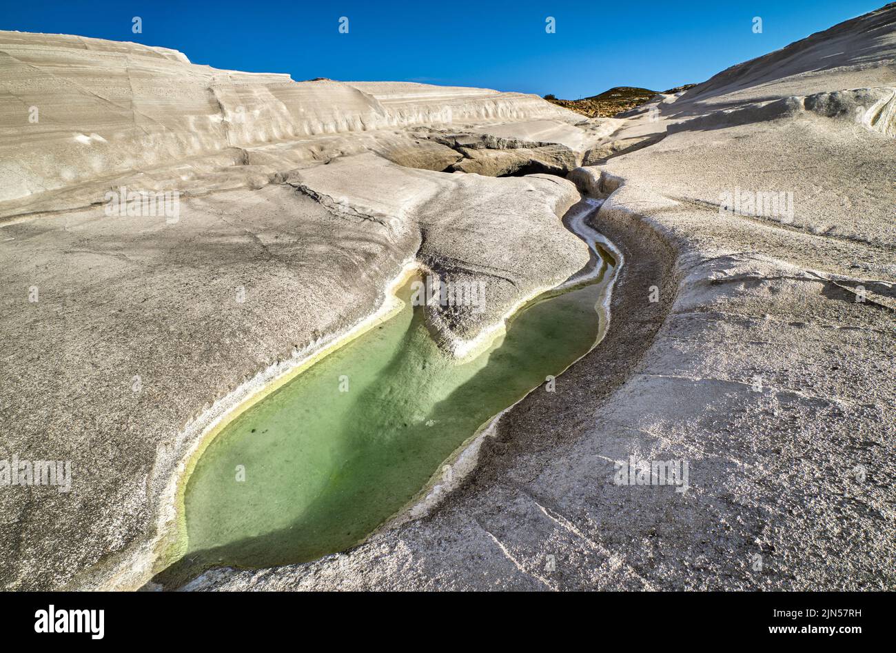 Unique white rocks on Sarakiniko beach and natural trapped water pool ...