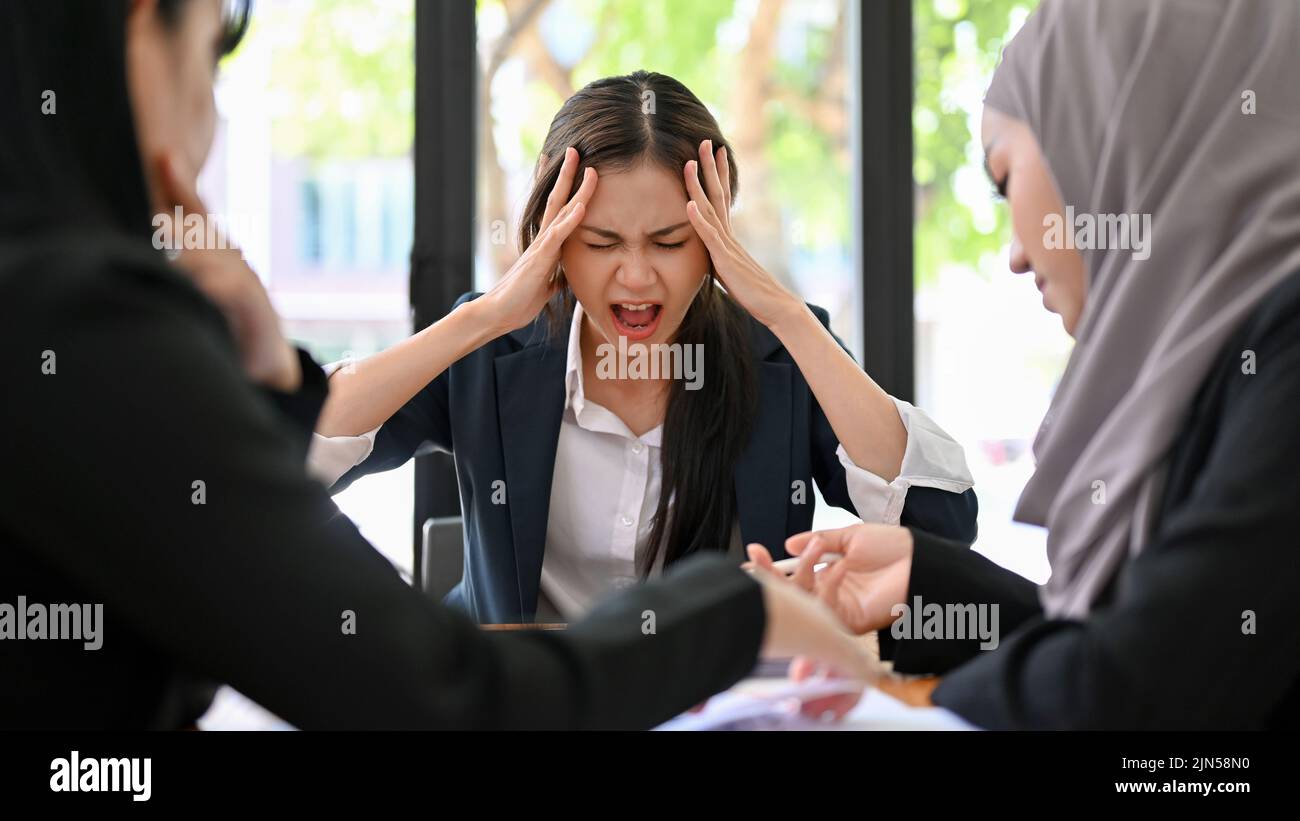 Angry and mad millennial Asian businesswoman or female boss in the ...