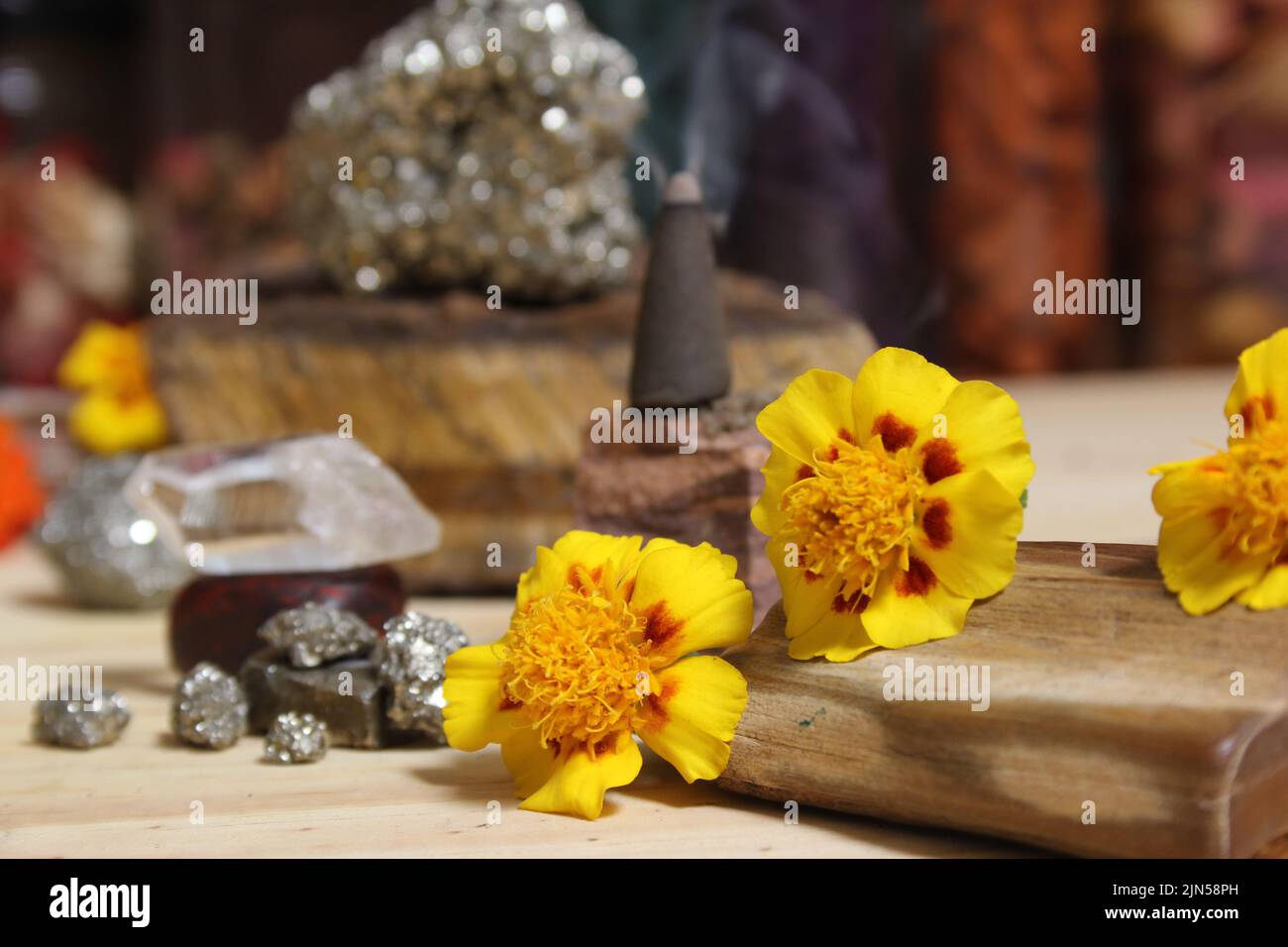 Incense Cone on Stone With Crystals and Flowers Stock Photo - Alamy
