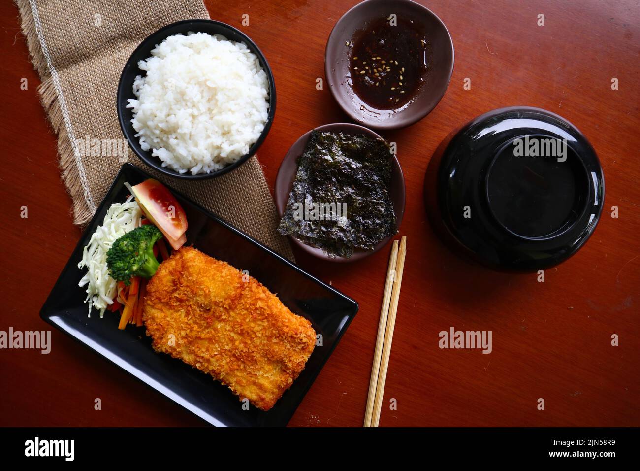 chicken katsu don is japanese food served with soy sauce on table Stock ...