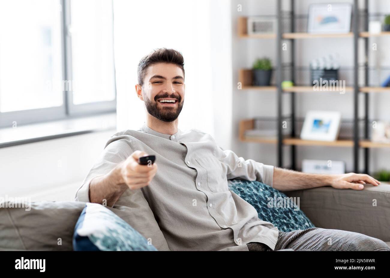 Man remote control watching tv hi-res stock photography and images - Alamy