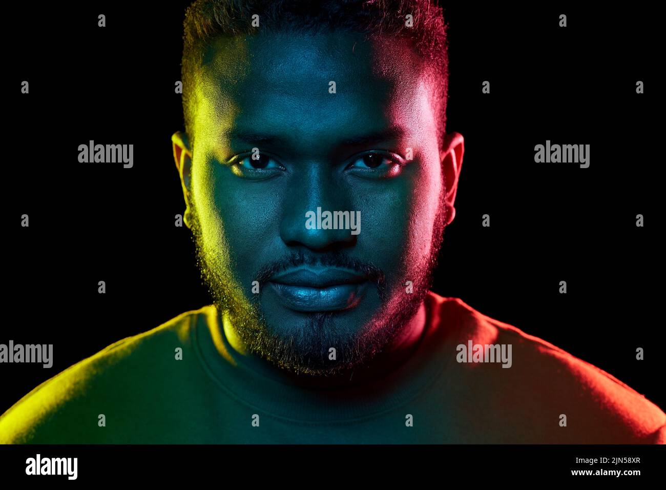 young african american man over black background Stock Photo - Alamy