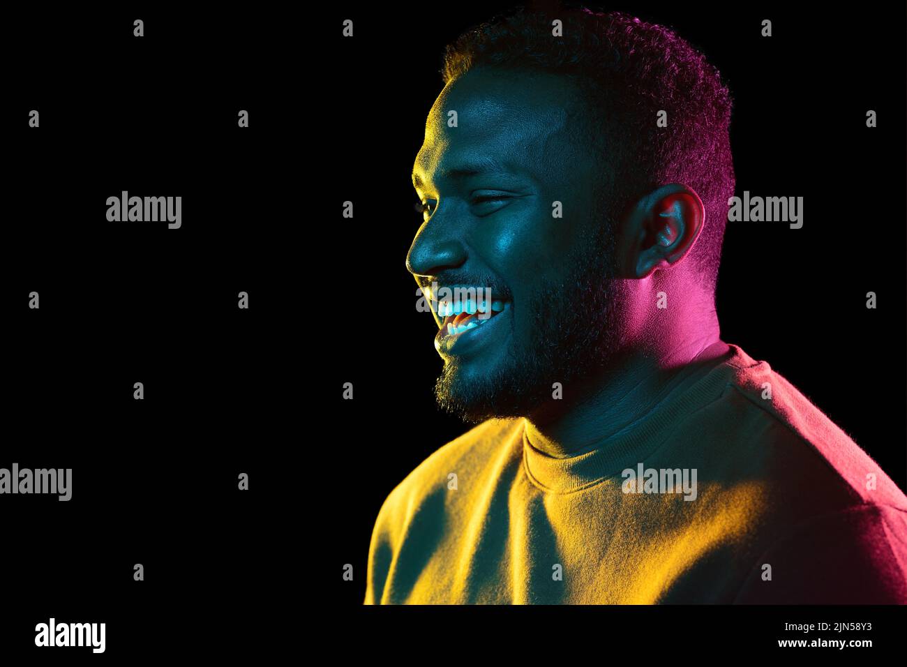 young african american man over black background Stock Photo - Alamy