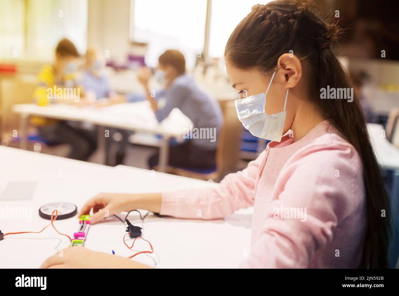 girl in mask building robot at robotics school Stock Photo - Alamy