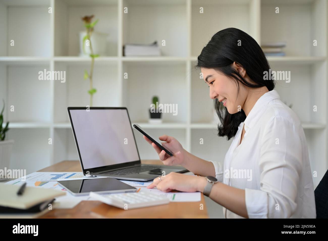 Beautiful Asian businesswoman or female accountant working at her ...