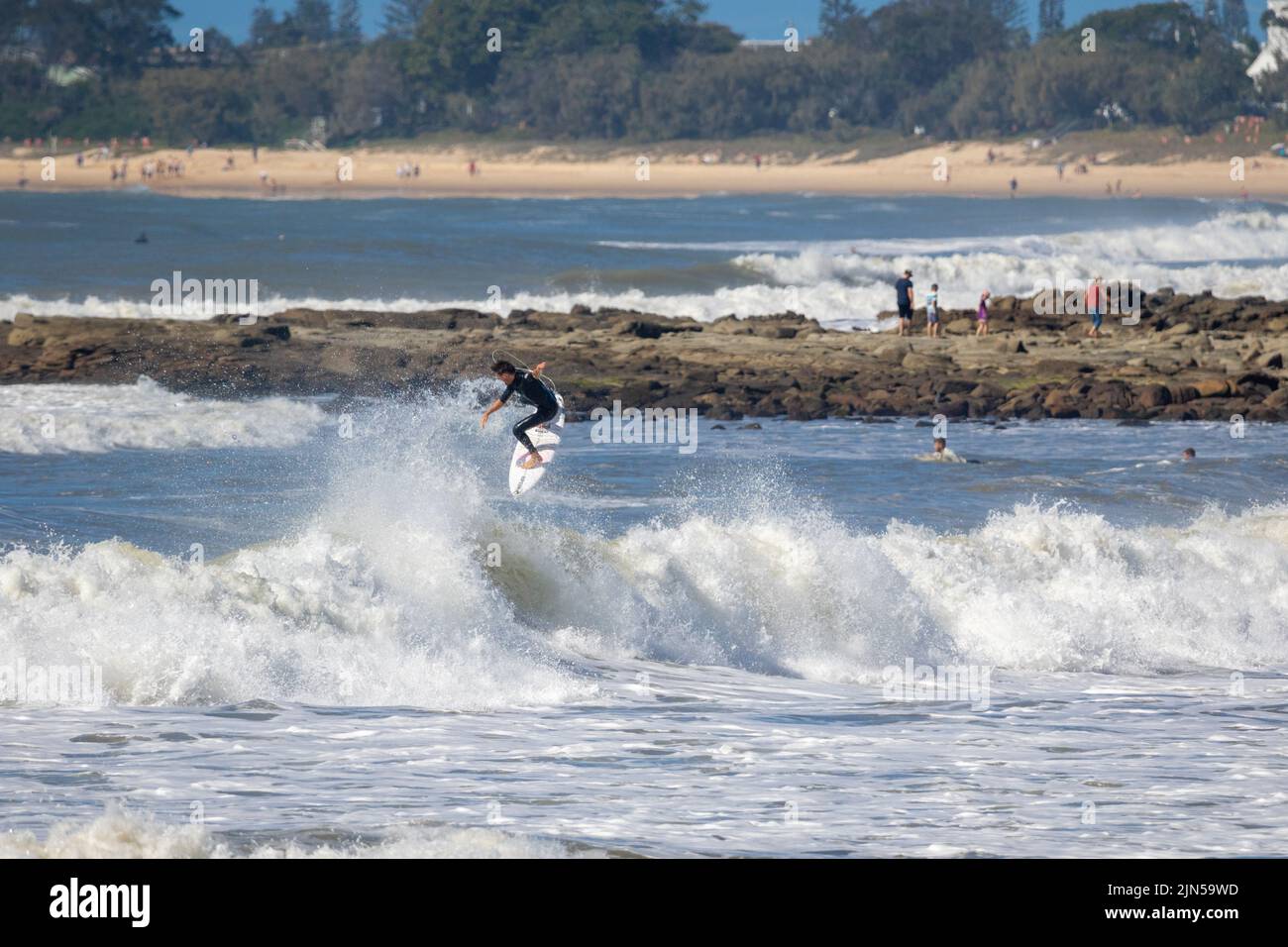 The surfer jumps above a wave. Alexandra Headland, Maroochydore ...