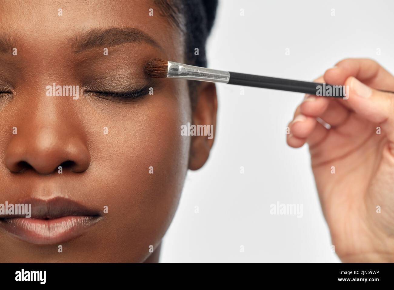 face of african woman and hand with make up brush Stock Photo - Alamy