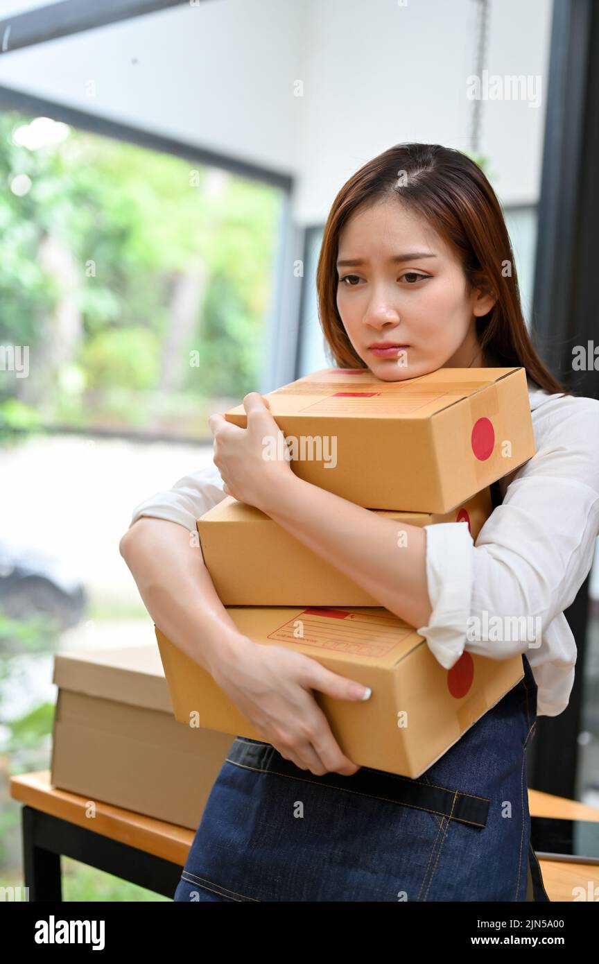 Portrait, Stressed and sad young Asian female e-commerce business ... Portrait, Stressed and sad young Asian female e-commerce business ...