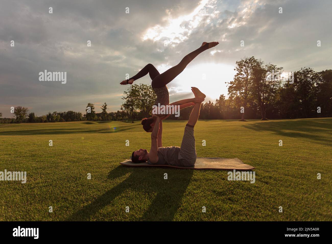 Strong acrobatic woman lifting man hi-res stock photography and images ...