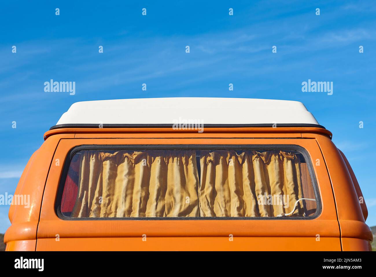 Vintage camper van under a blue sky. Recreational vehicle. Lifestyle ...