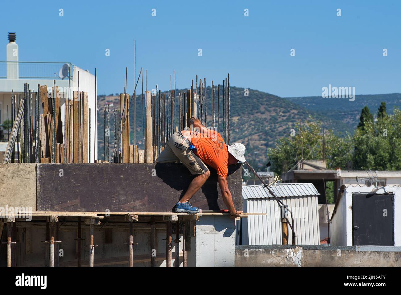 Building an apartment building, construction workers are working hard ...