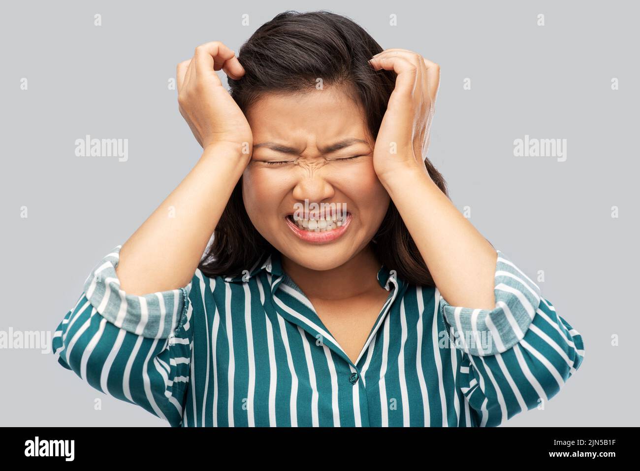 Young asian suffering headache isolated hi-res stock photography and images - Alamy