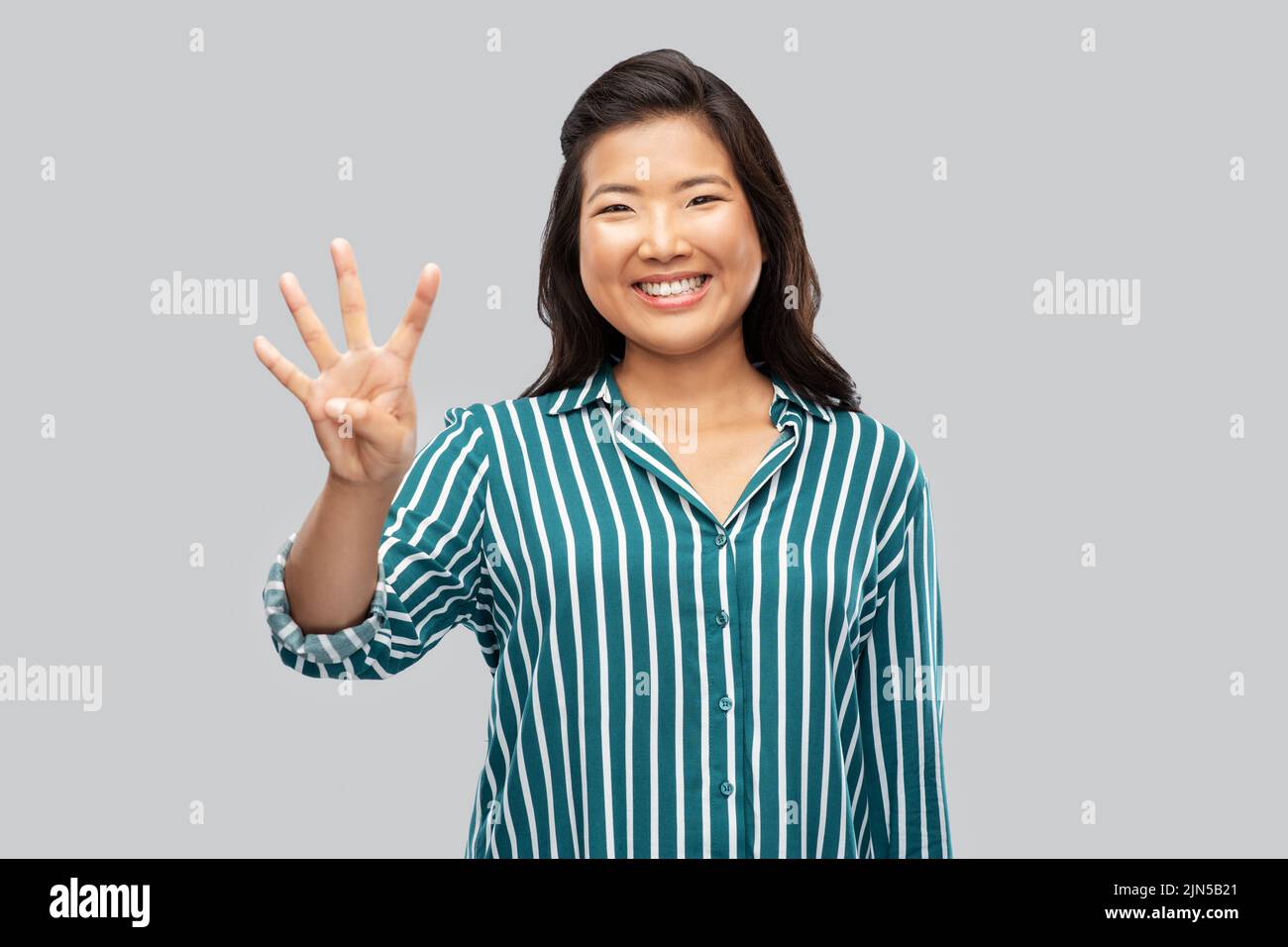 happy asian woman showing four fingers Stock Photo - Alamy