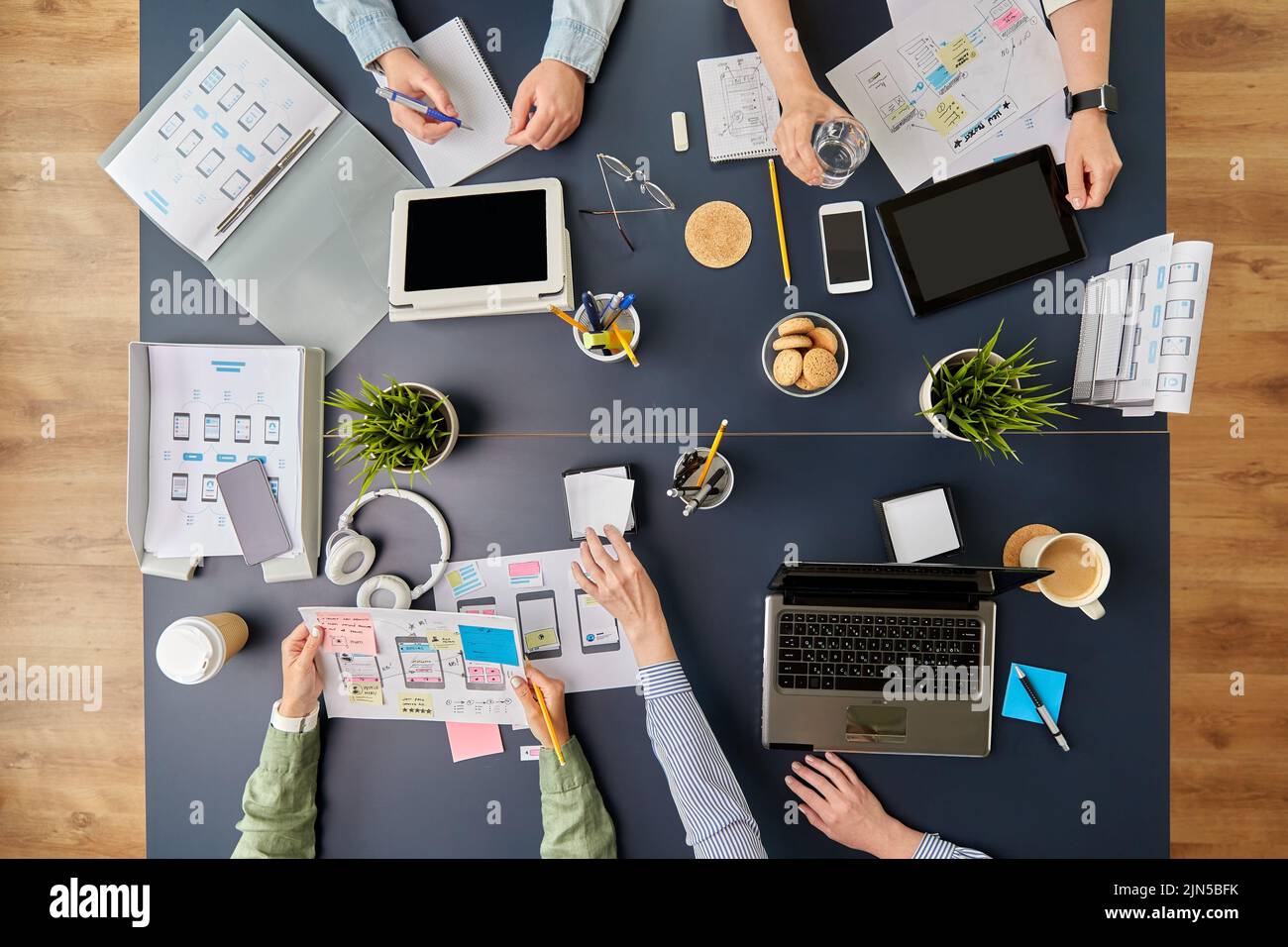 business team with gadgets working at office table Stock Photo - Alamy