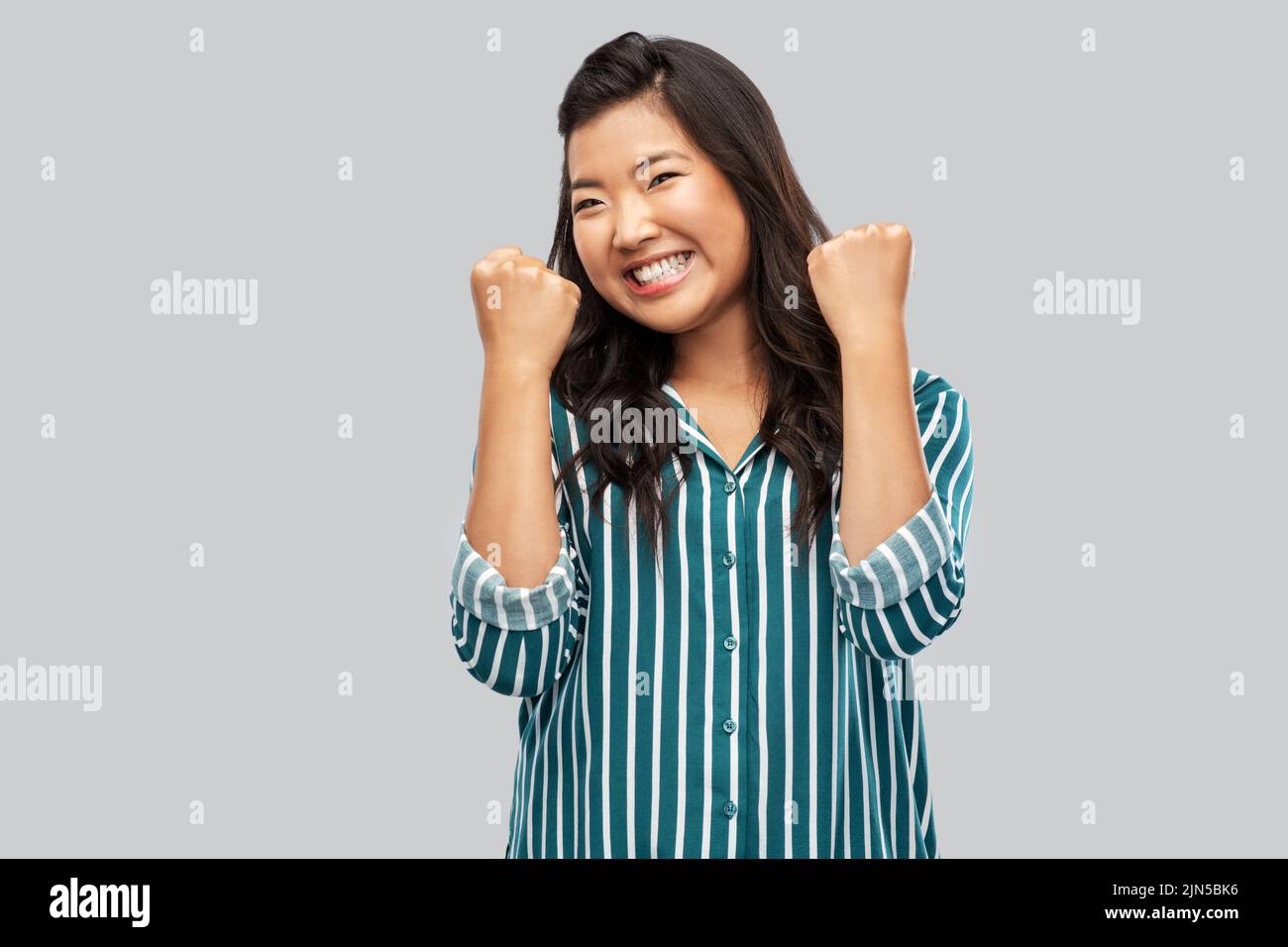 happy asian woman celebrating success over grey Stock Photo - Alamy