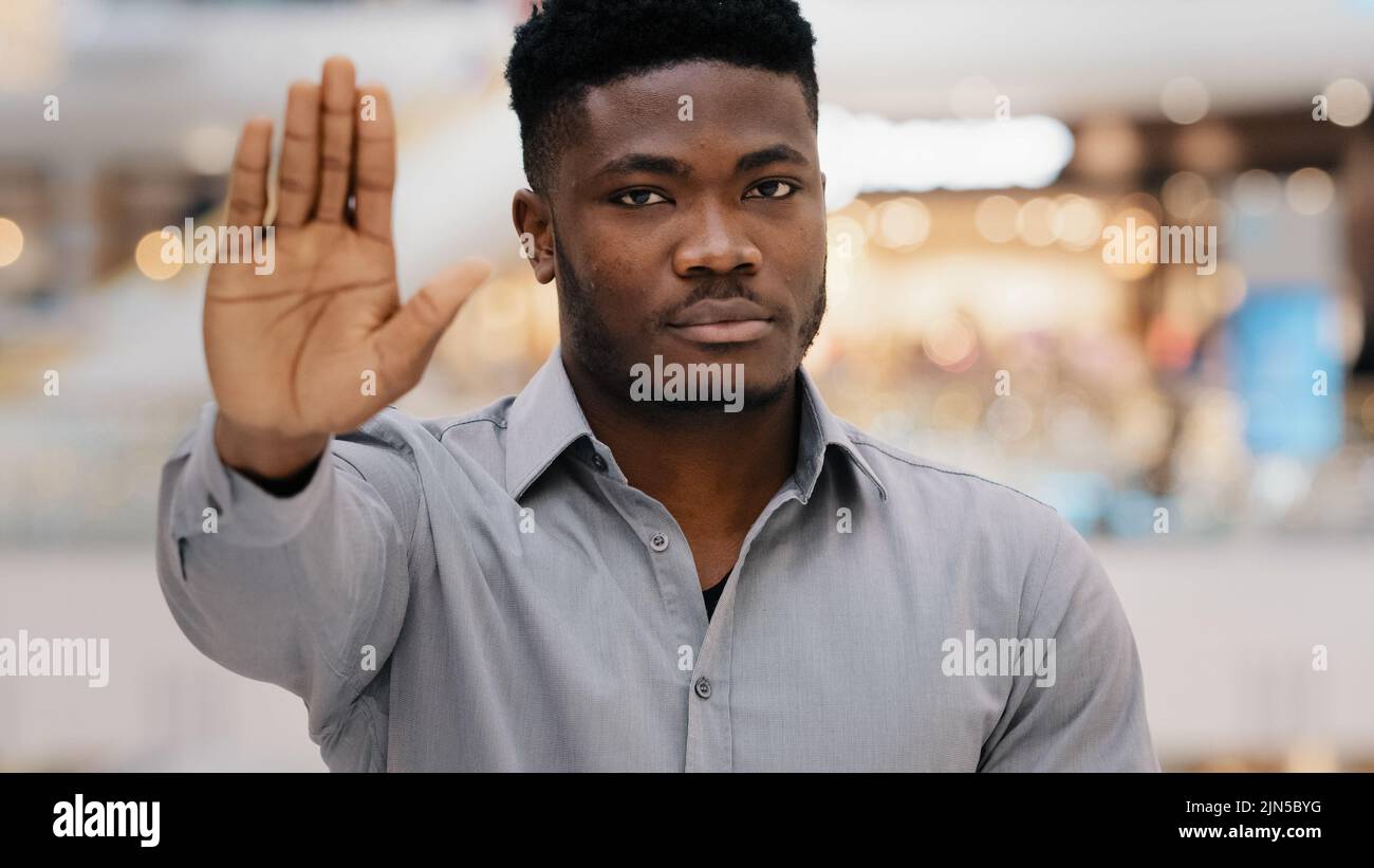 Close-up of young serious confident african american man looking at ...