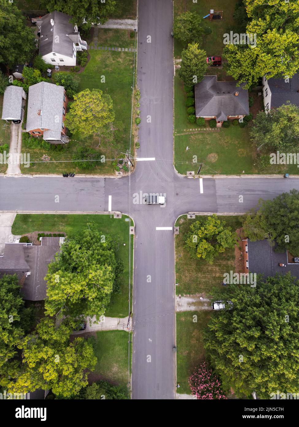 A vertical shot of the intersection with a car in the middle Stock ...