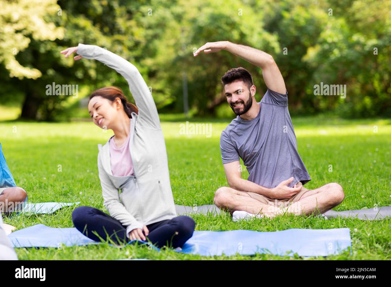group of people exercising at summer park Stock Photo - Alamy
