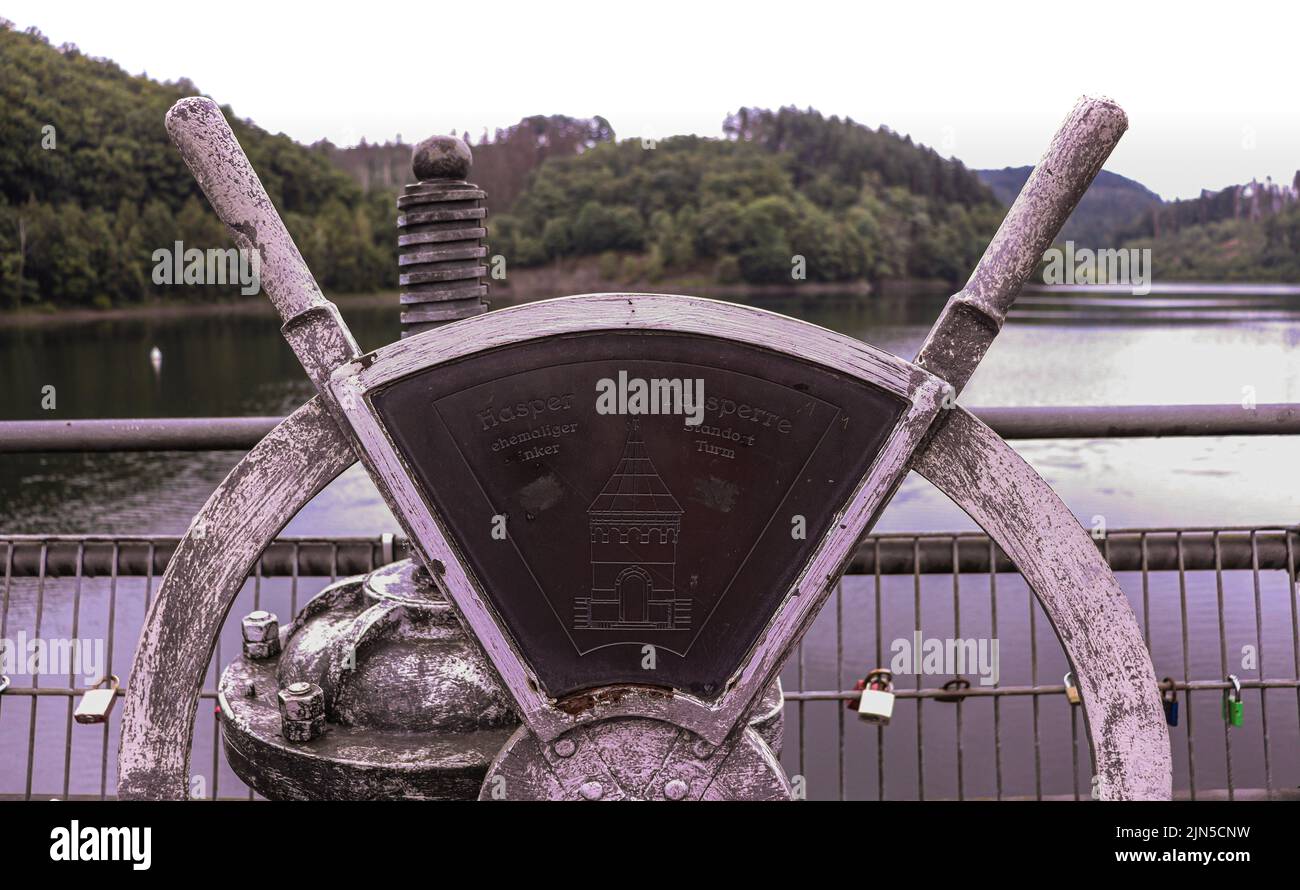 A closeup of an old white helm with a beautiful lake amid a forest in ...