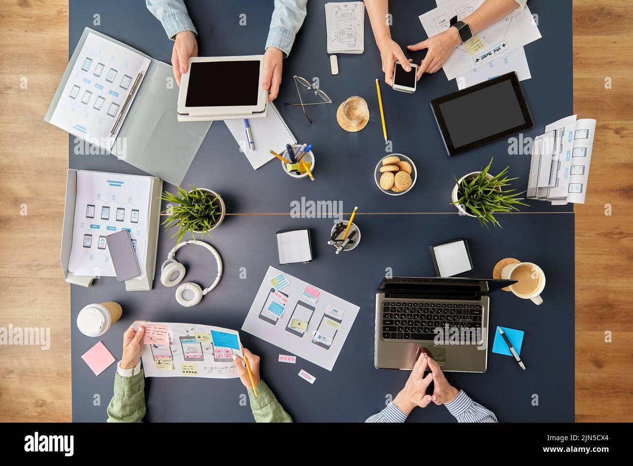 business team with gadgets working at office table Stock Photo - Alamy