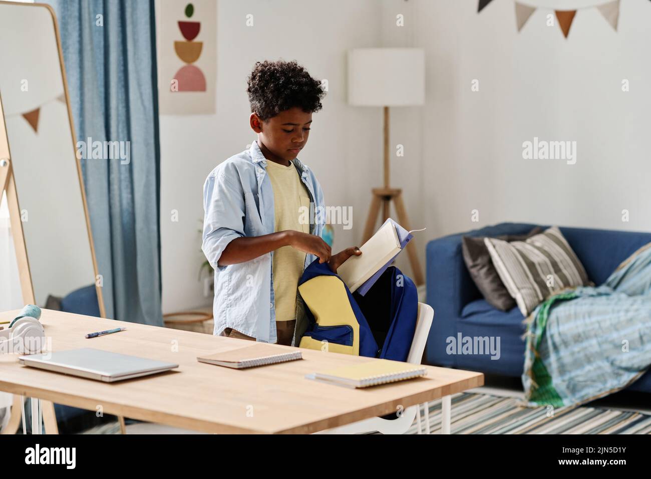Boy bag book putting hi-res stock photography and images - Alamy