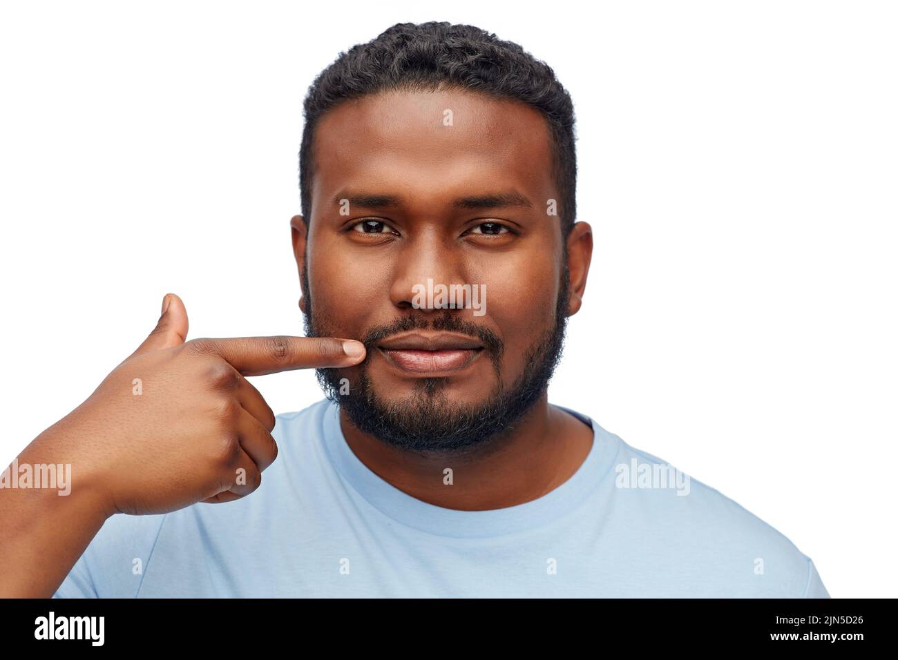 african american man pointing finger to his mouth Stock Photo - Alamy