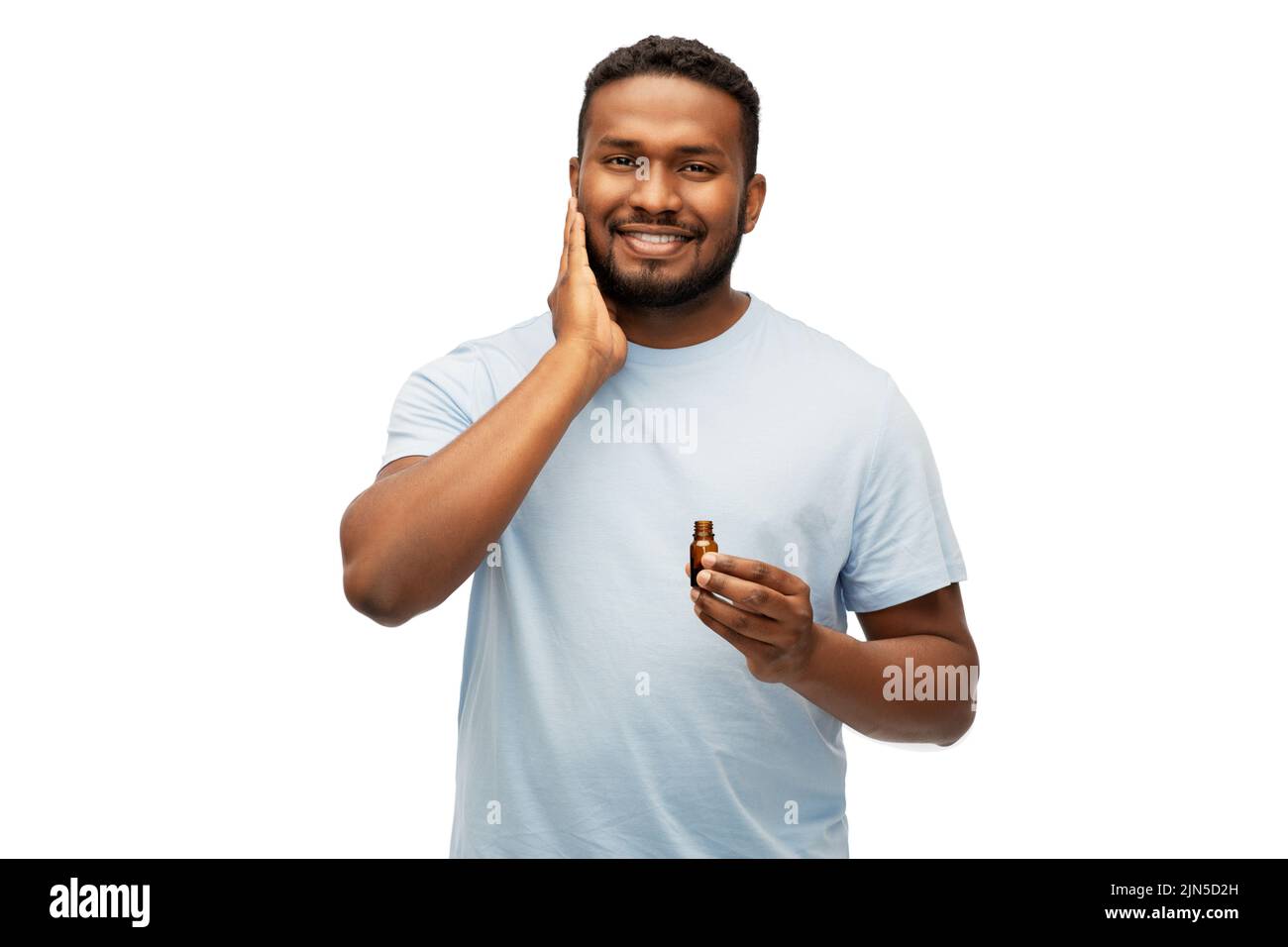 african man applying grooming oil to beard Stock Photo - Alamy