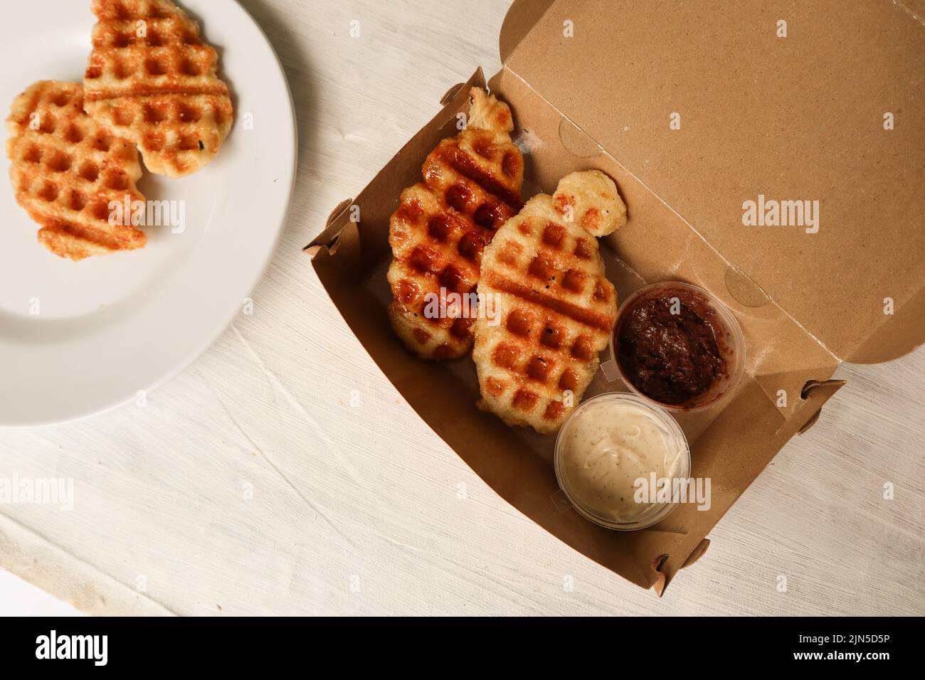 Croissant Waffle or Croffle with chocolate sauce served in box and ...