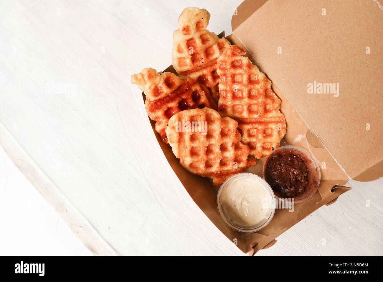 Croissant Waffle or Croffle with chocolate sauce served in box and ...