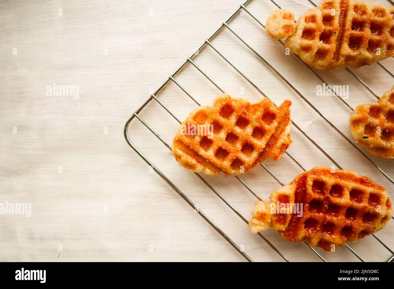 Croissant Waffle or Croffle with chocolate sauce served in box and ...