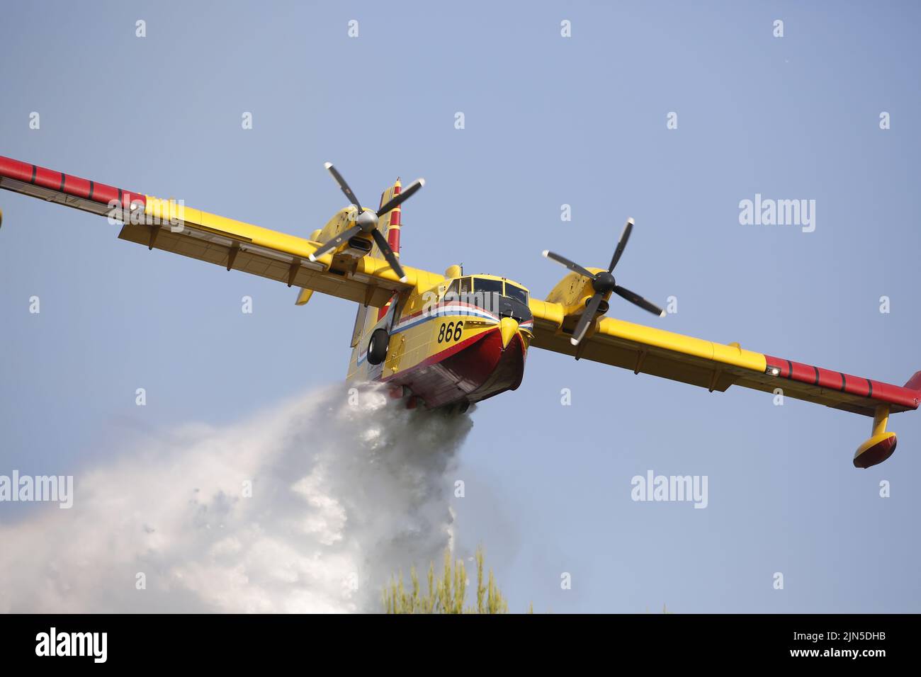 A Croatian Air Force Canadair CL-415 releases water as it extinguishes ...