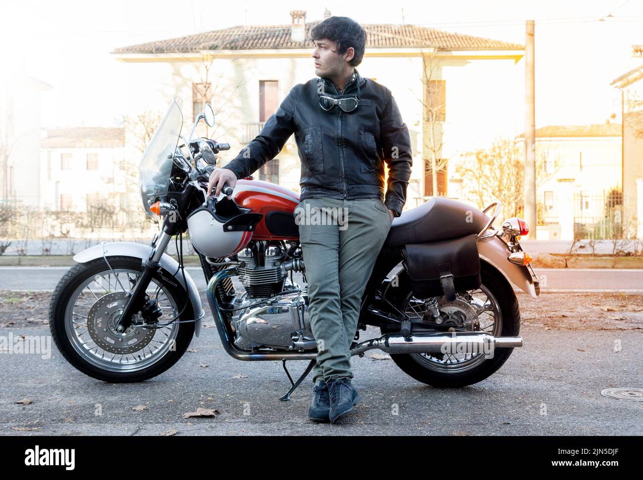 young biker relaxing leaning your motorcycle Stock Photo - Alamy