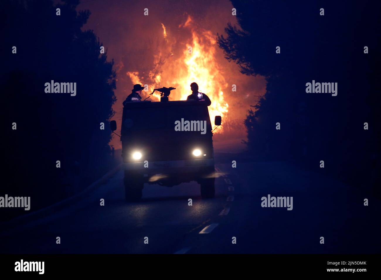 Croatian fire workers controls fire during forest fire on the Peljesec ...