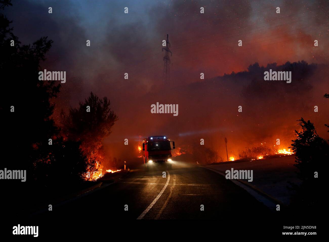 Croatian fire workers controls fire during forest fire on the Peljesec ...