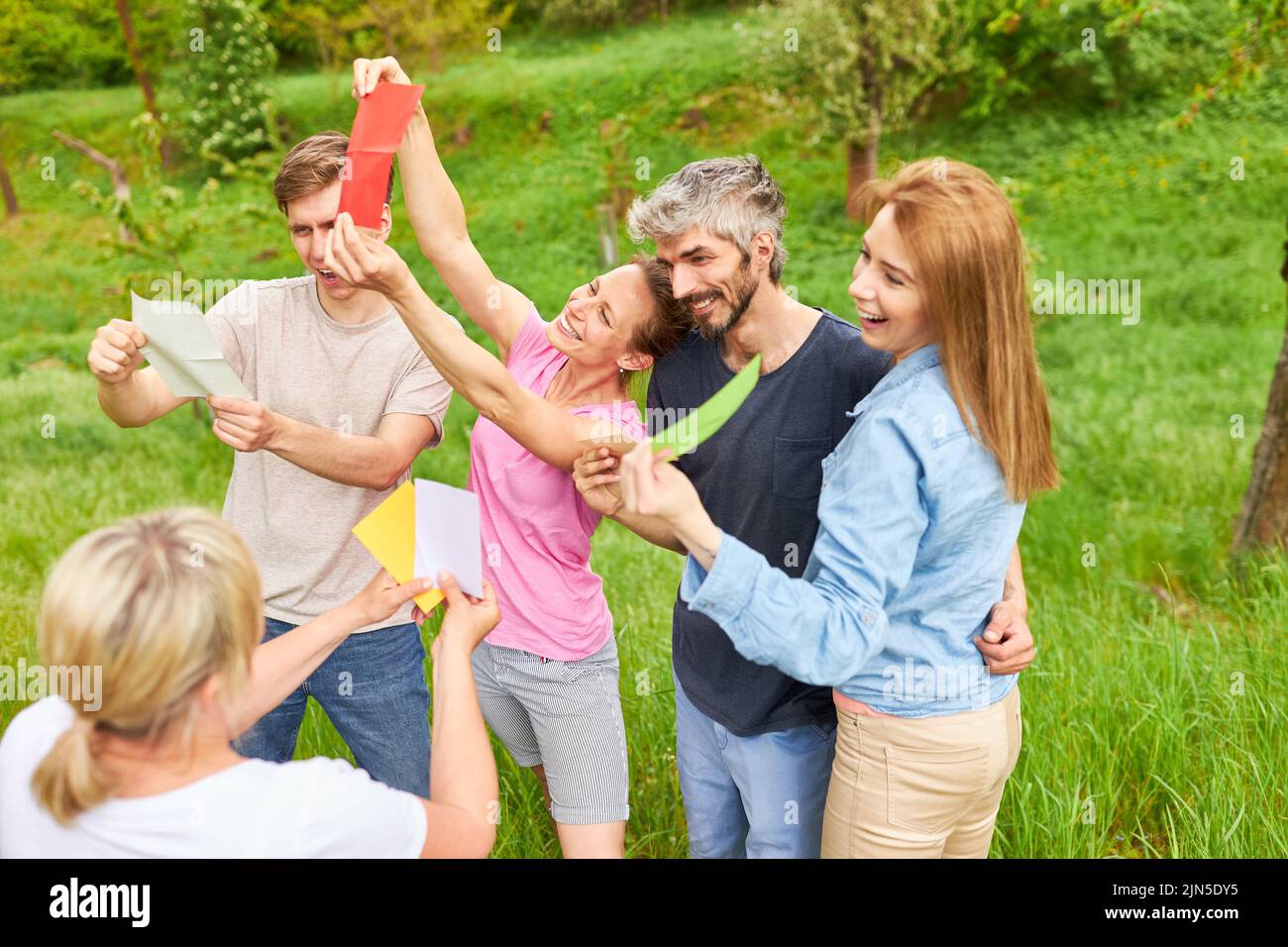 Young people read colorful cards to get to know each other in the team ...