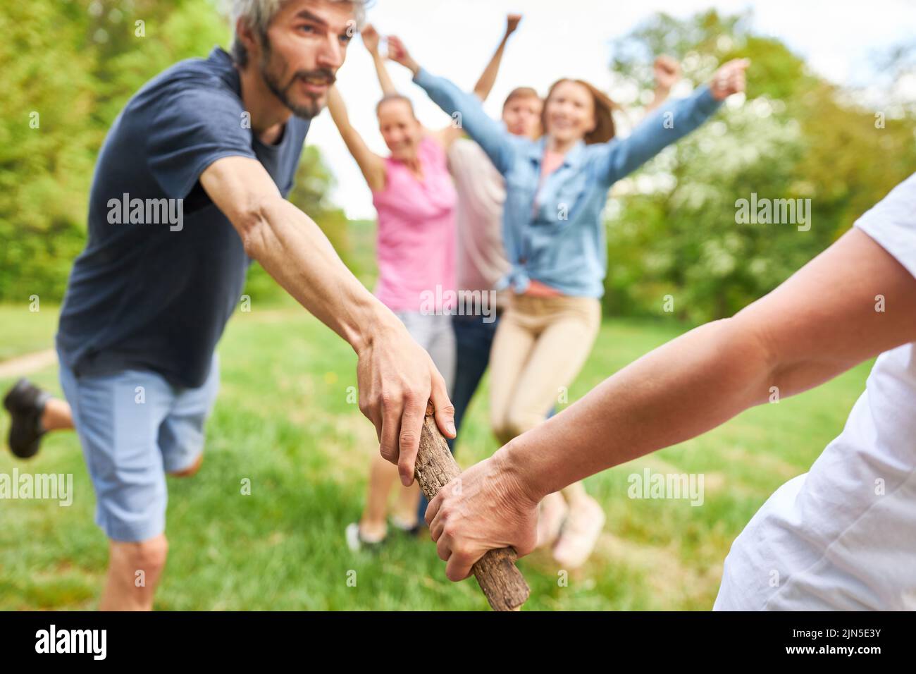 Young man passes the baton to team colleagues in the race at the team ...