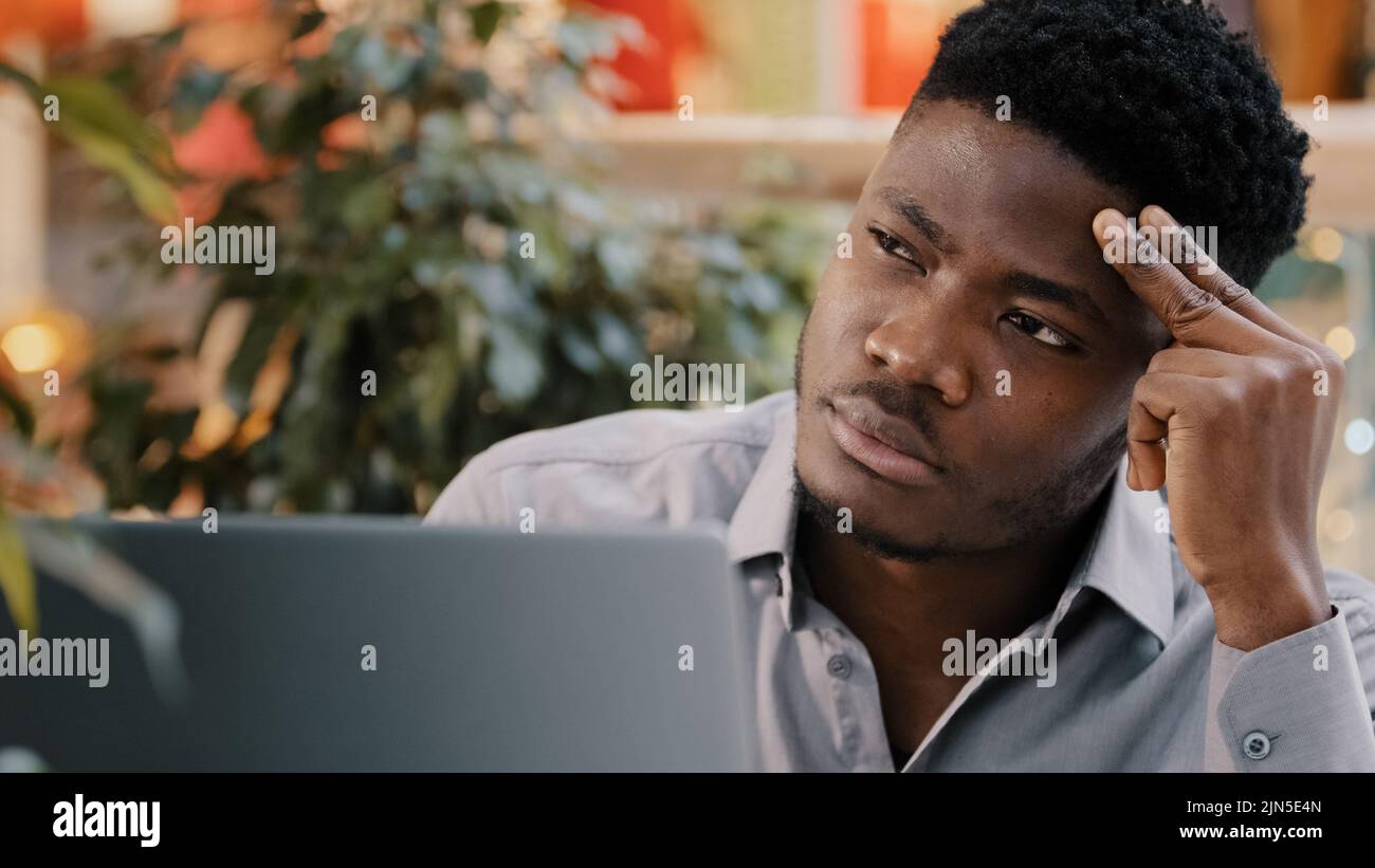 Close-up young male businessman looking at laptop screen receiving ...
