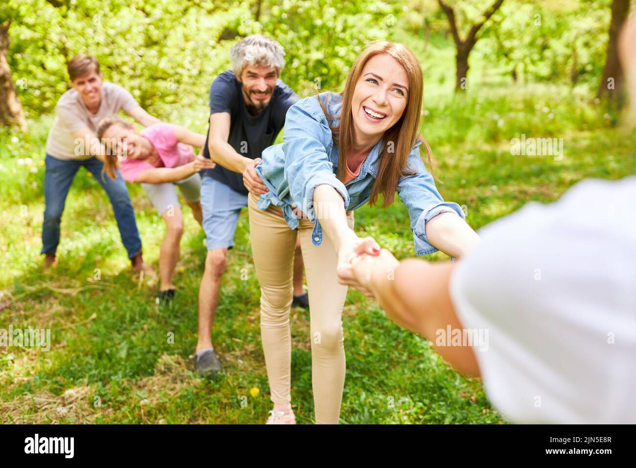 Two teams have fun measuring strength in team building competition in ...