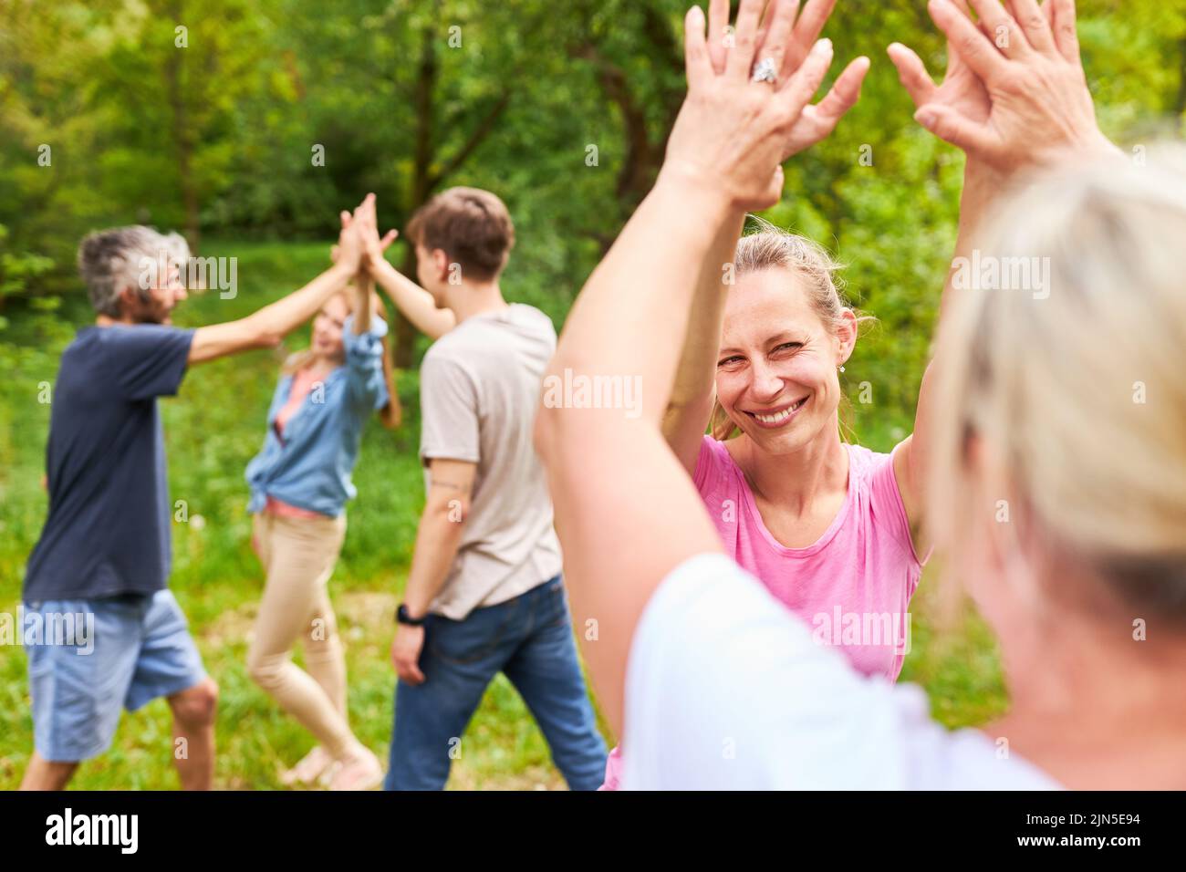 Winning team celebrates success in outdoor competition by giving high ...