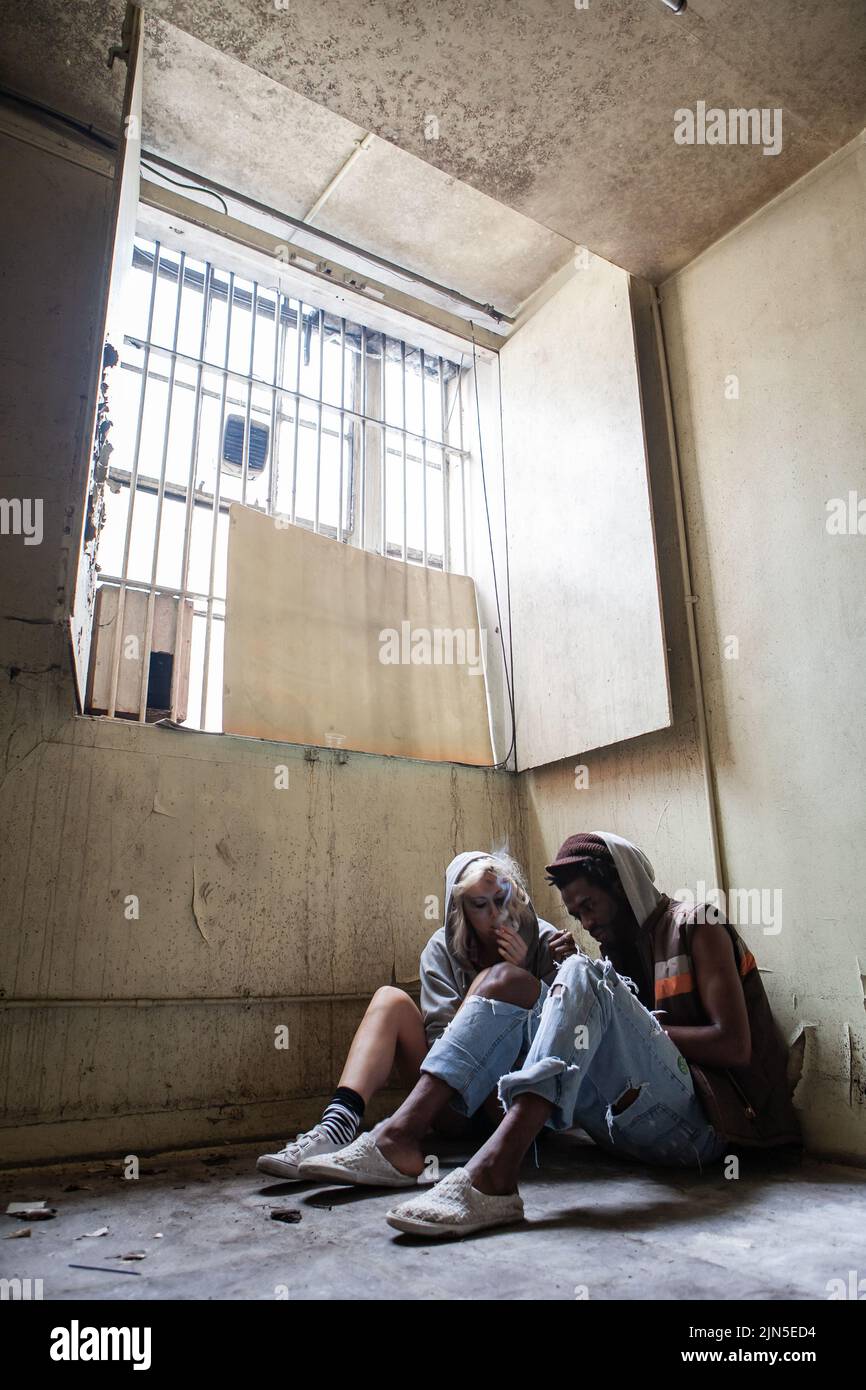 Substance Abuse, smoking. A pair of drug users sharing their fix ...