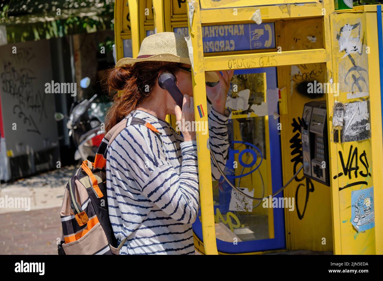 woman using a public telephone in central Athens Stock Photo - Alamy
