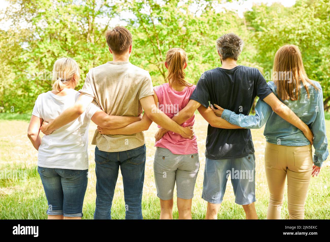 Young people stand side by side in an embrace on a summer outing in ...