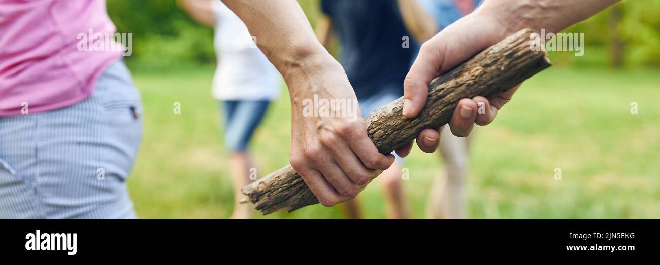Passing hands on wooden baton at outdoor competition in summer Stock ...
