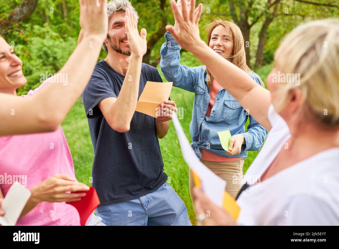 Team of young people giving high five for cooperation and team building ...