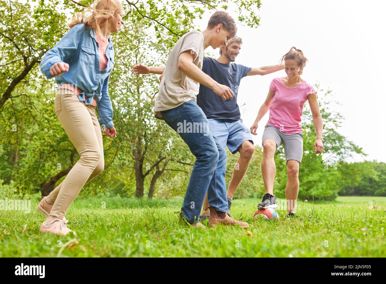 Group of friends playing soccer in summer for fun or training for ...
