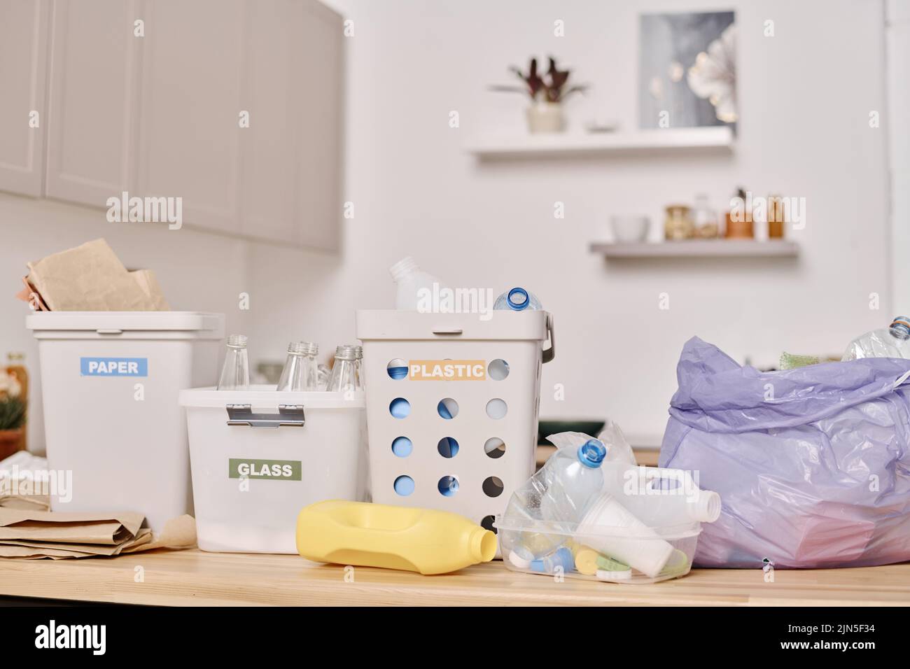 Horizontal image of separated garbage in different containers standing ...