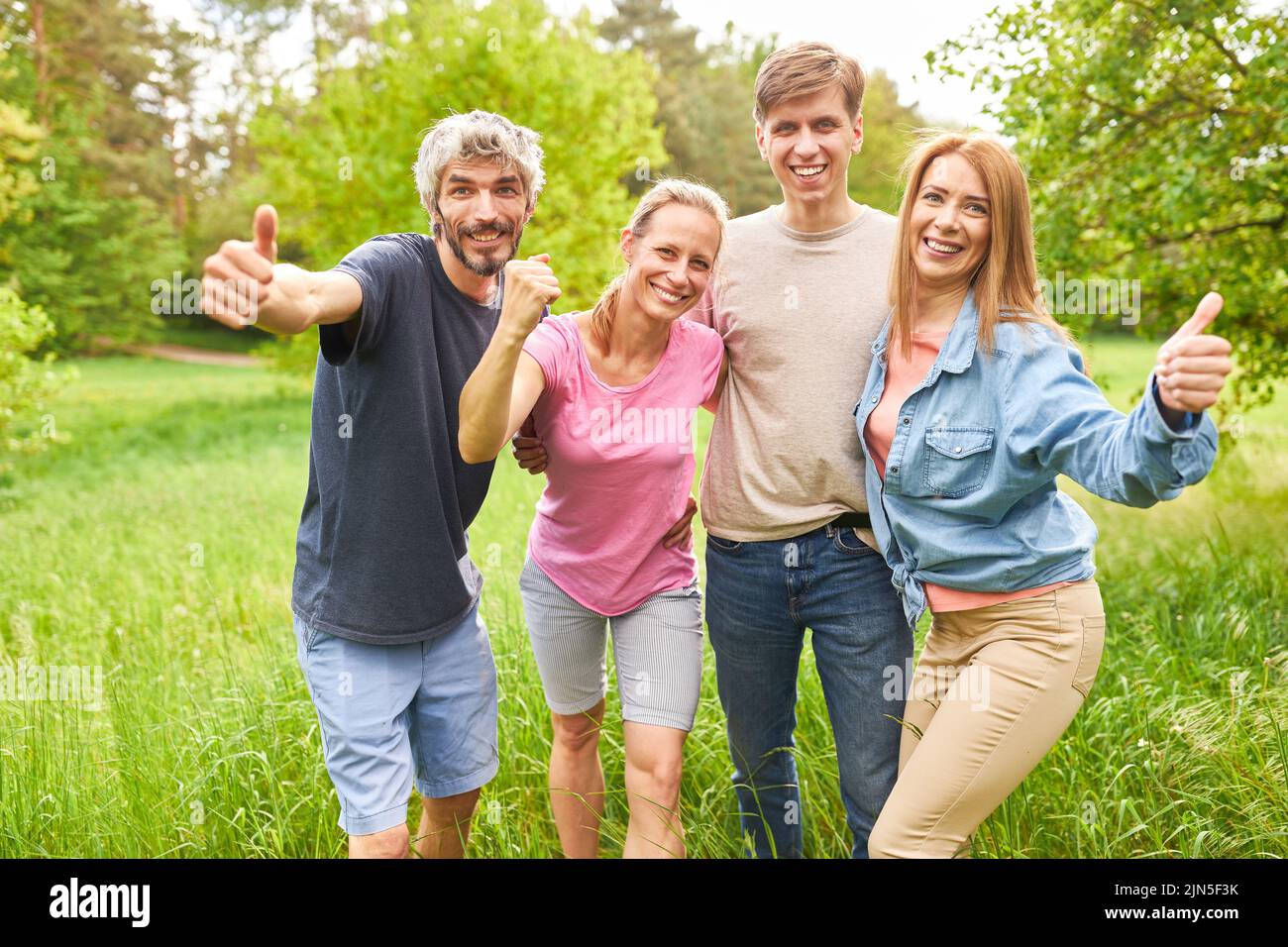 Young people as friends on an excursion in nature with optimism and ...