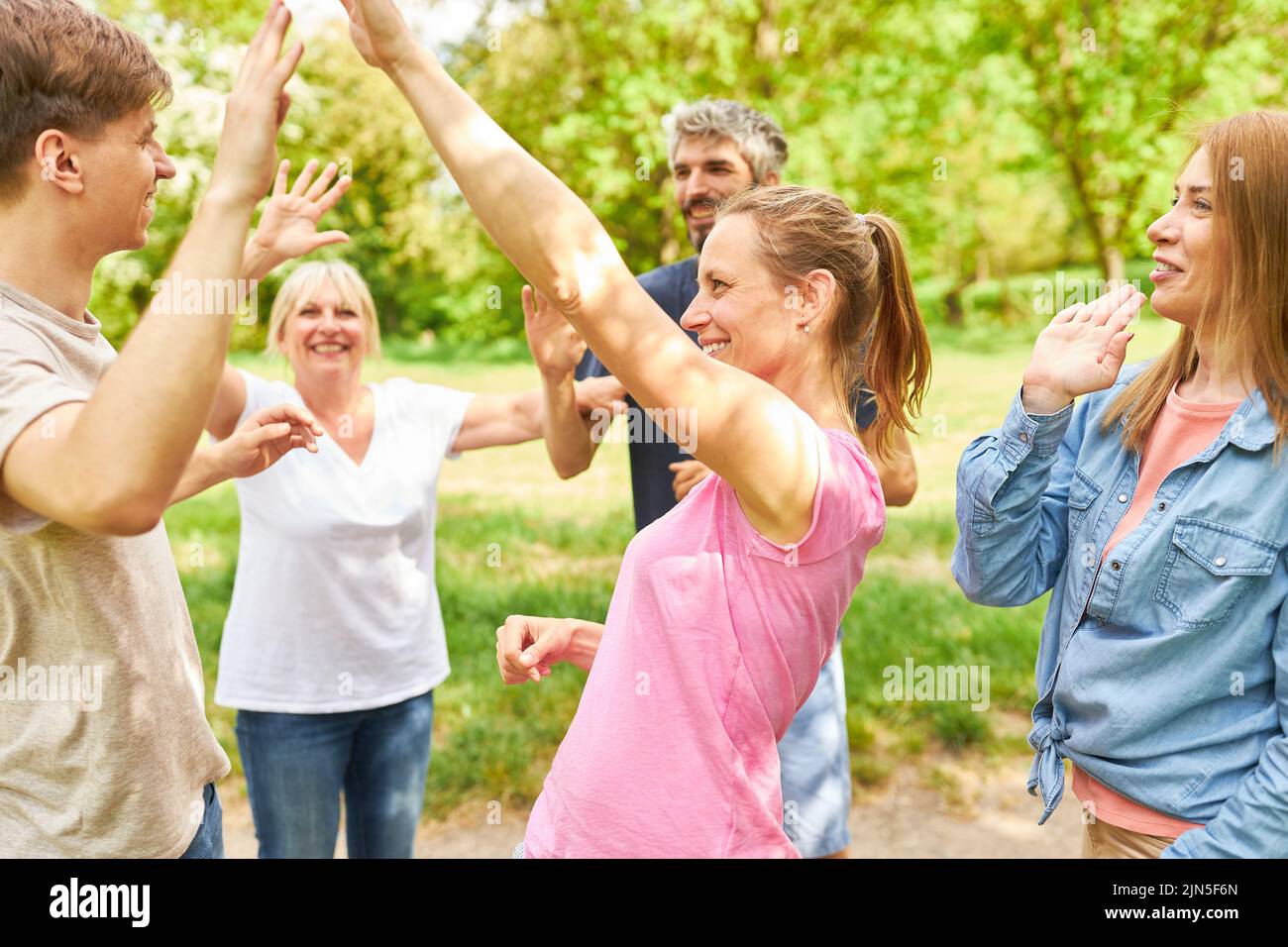 Group of young people doing exercise for motivation and cooperation in ...