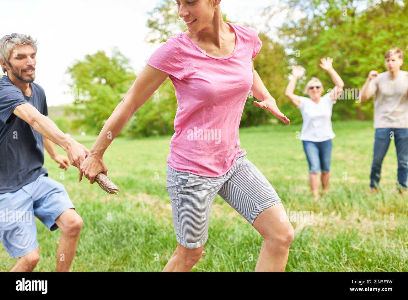 Young woman takes over the baton from team colleagues in the race at ...
