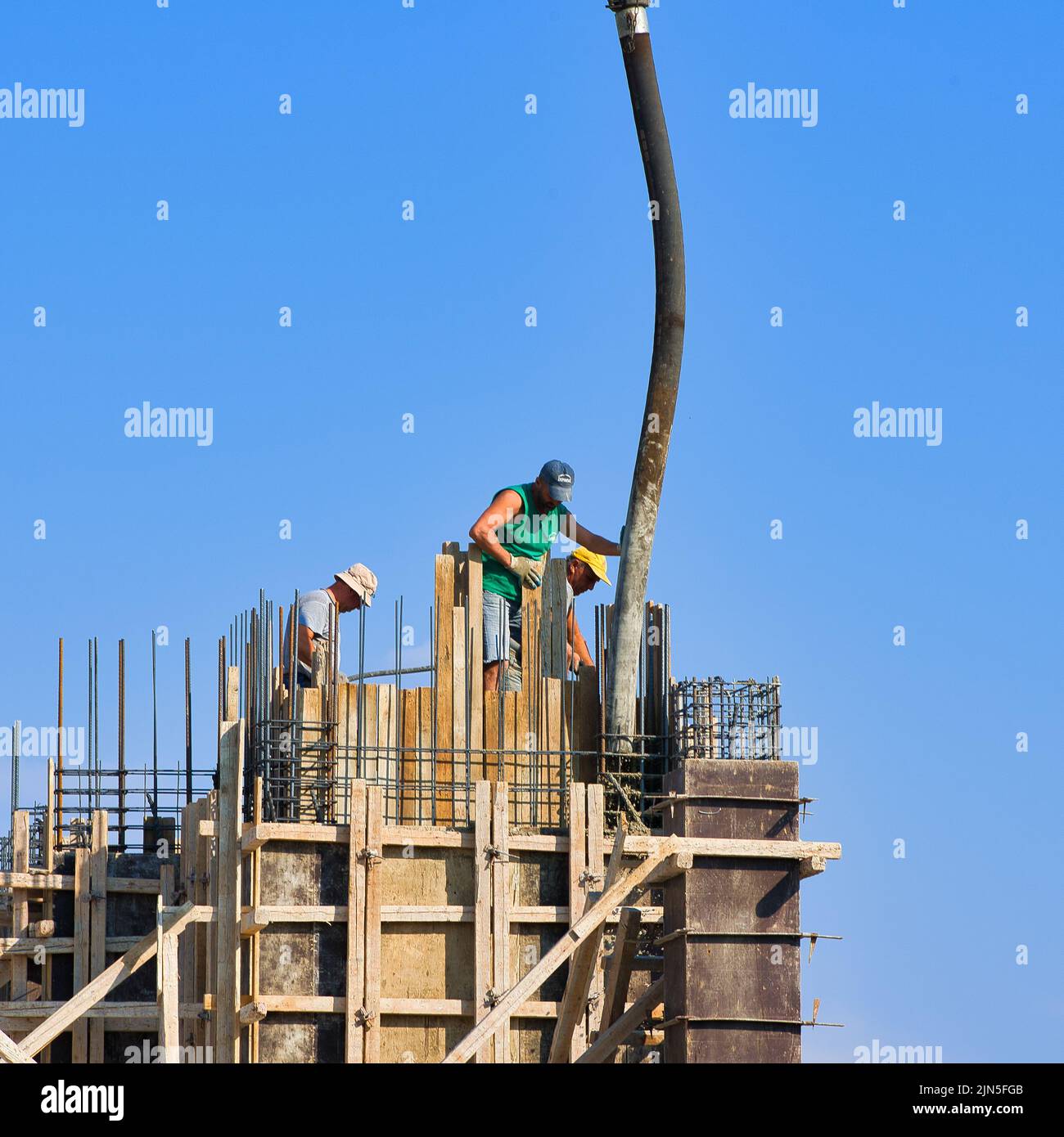 Building an apartment building, construction workers are working hard ...